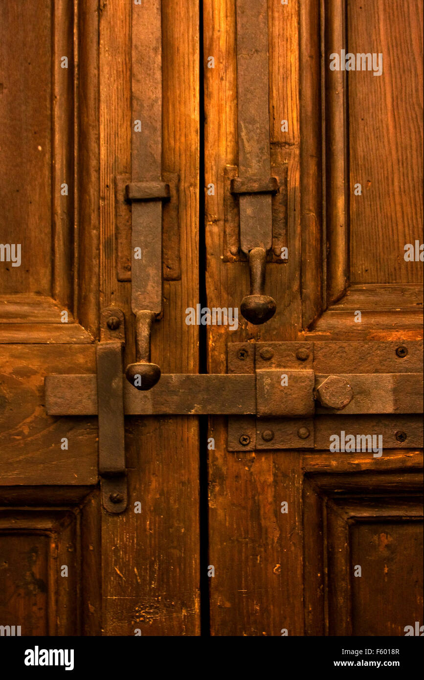 brown iron safety lock in a closed wood door in naples italy Stock ...