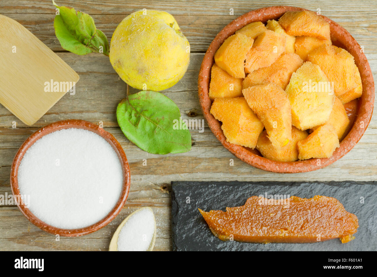 Spanish quince paste on a slate plate and ingredients on wooden ...
