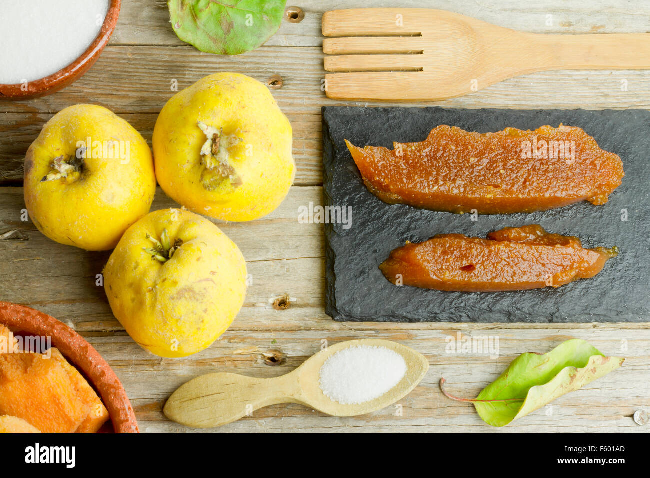 Spanish quince fruits and paste with ingredients on wooden background ...