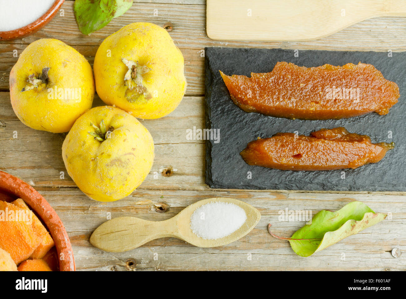 Spanish quince fruits and paste with ingredients on wooden background ...