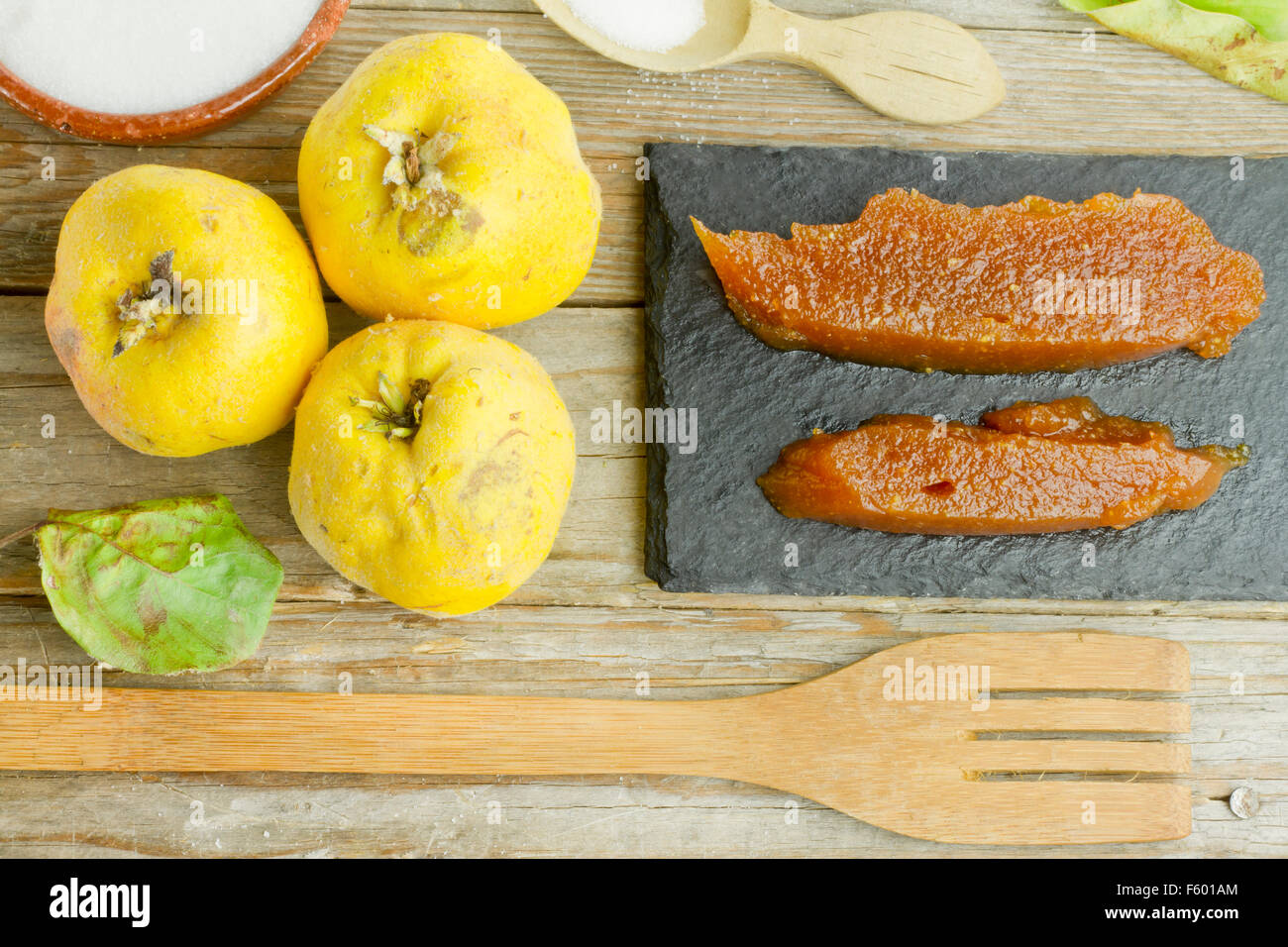 Spanish quince fruits and paste with ingredients on wooden background ...
