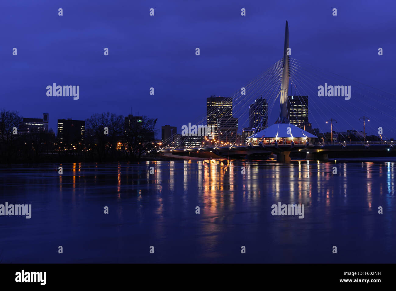 night shot of Esplanade Riel pedestrian bridge on the Red river between ...