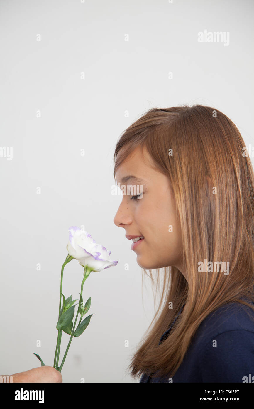 Pretty girl smelling the flowers Stock Photo - Alamy