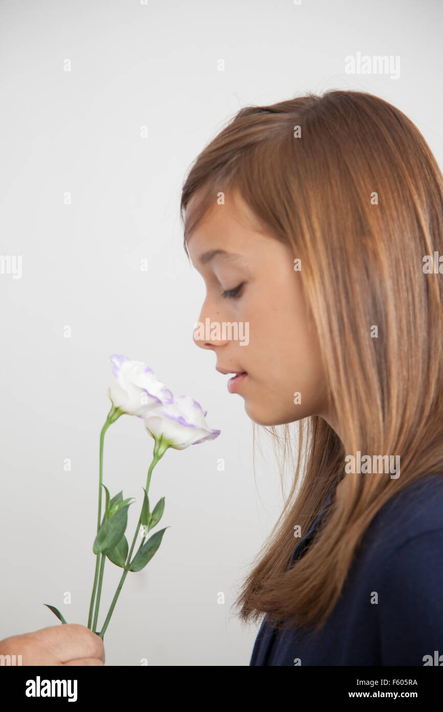 Pretty girl smelling the flowers Stock Photo - Alamy