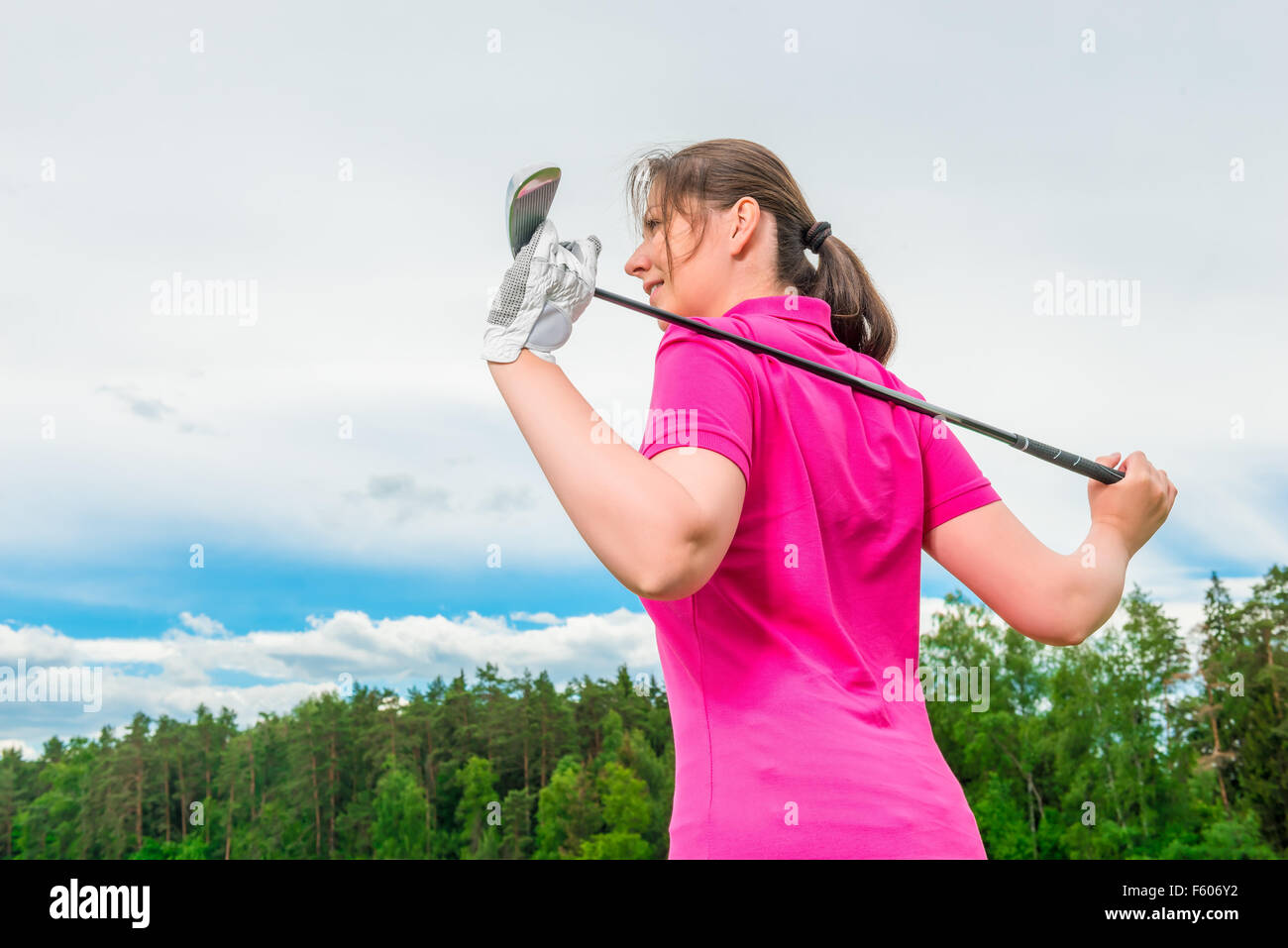 Happy cute brunette on the golf course Stock Photo - Alamy