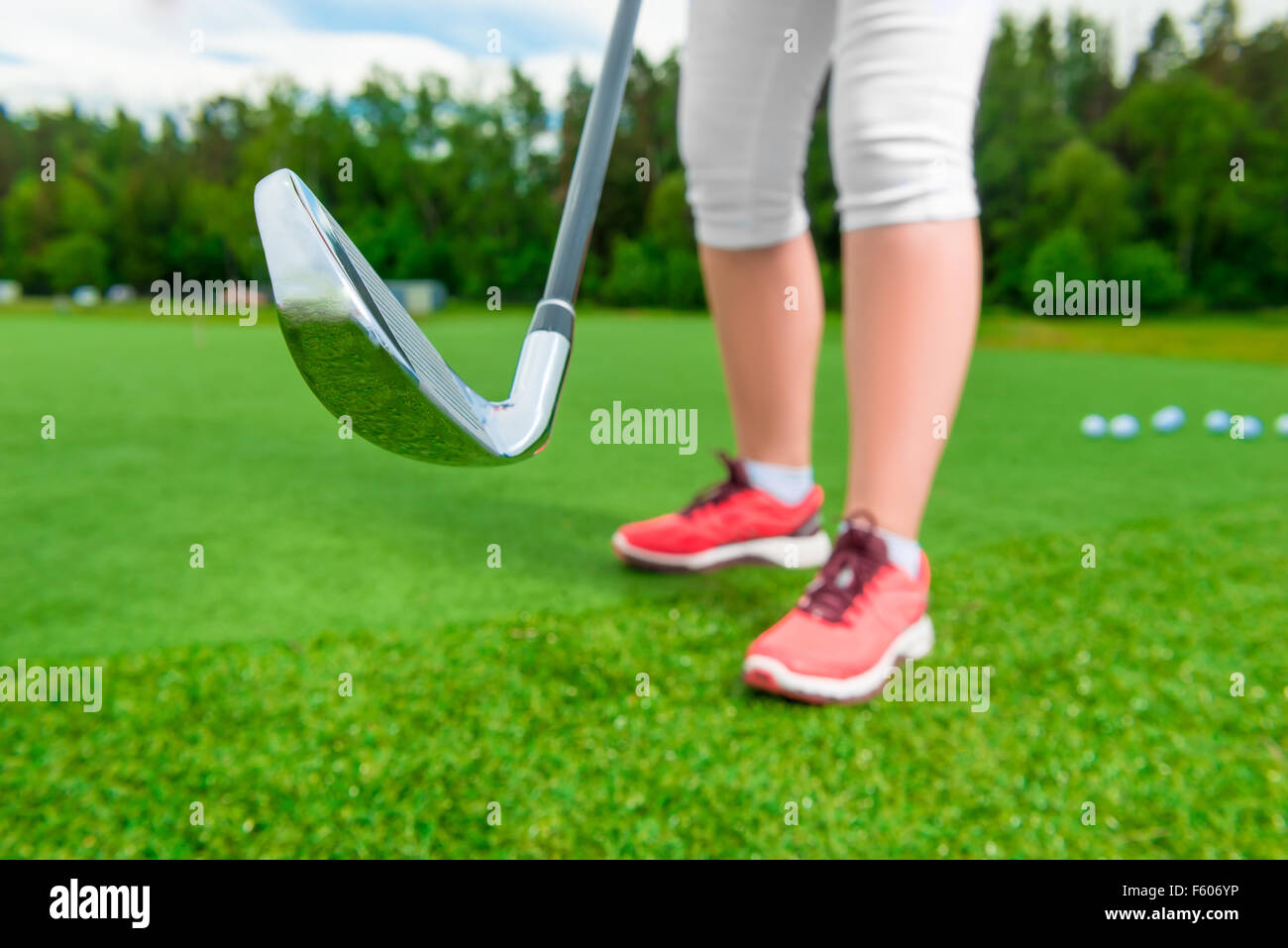 Ladies feet and golf putter on the green grass Stock Photo - Alamy