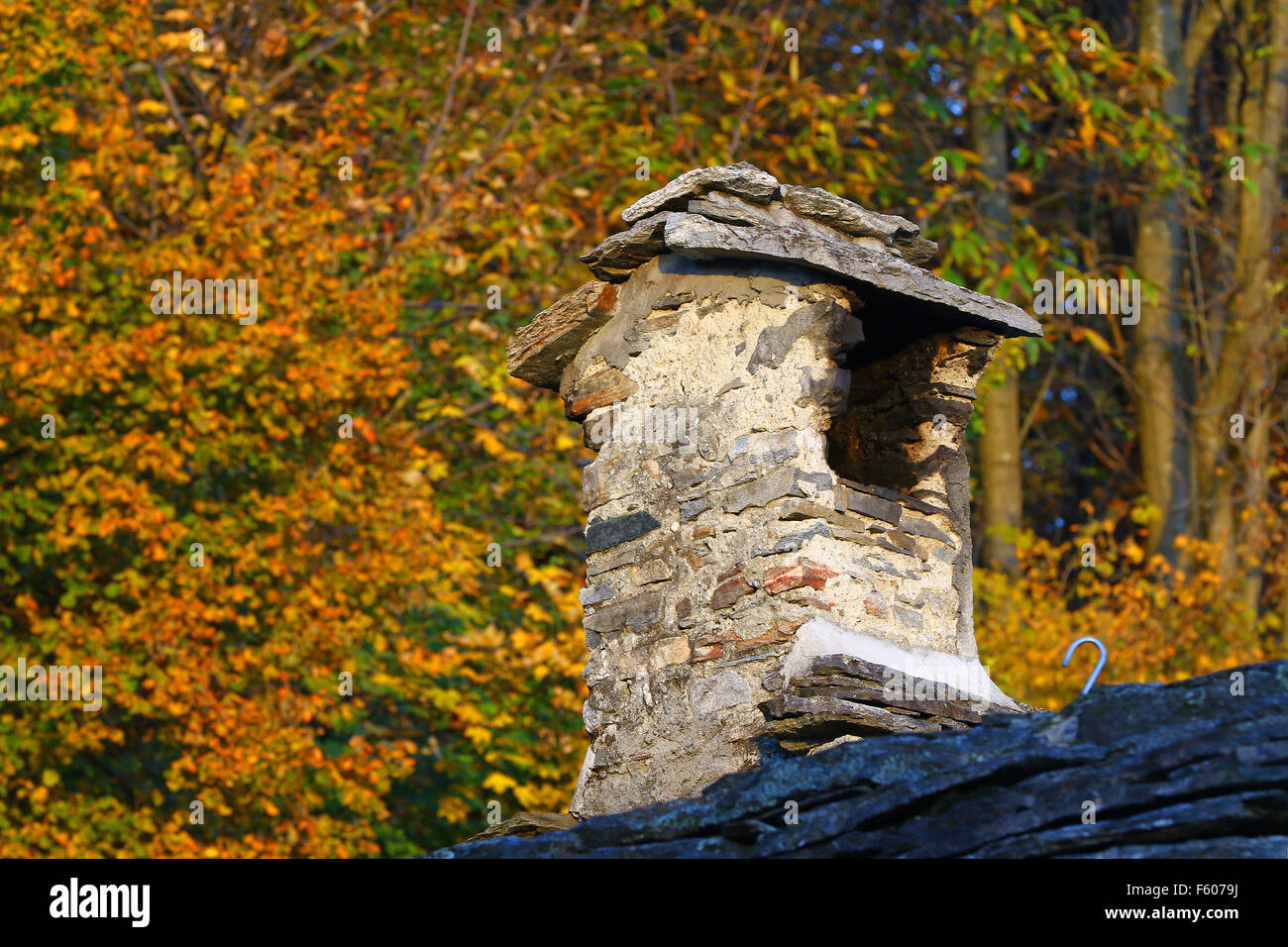 Old granite block chimney in front of a colorful autumn forest Stock ...