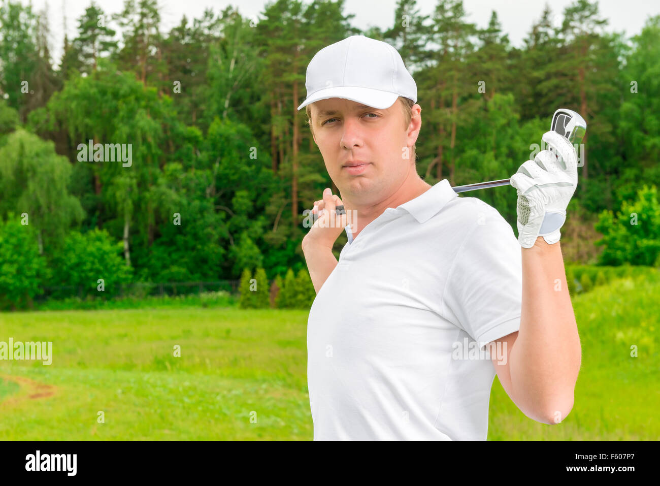 male golfer with a golf club on the field Stock Photo - Alamy