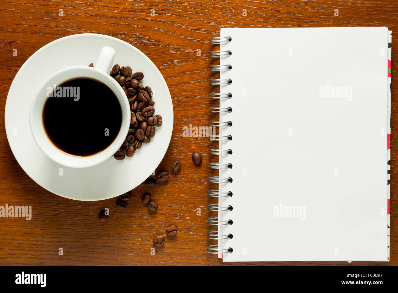 note pad and a cup of coffee with roasted grains Stock Photo - Alamy