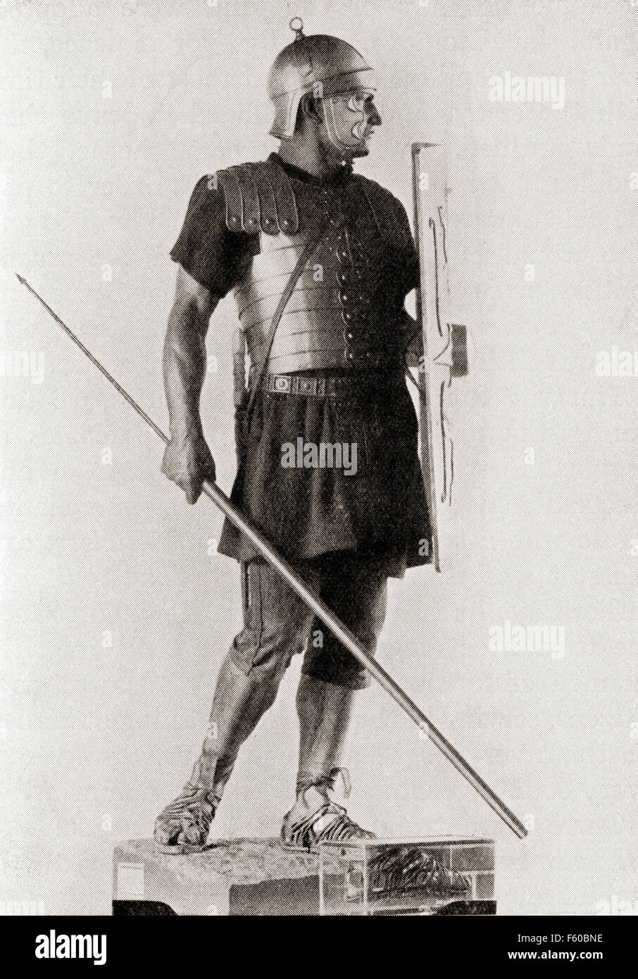 A life size model of a Roman infantryman holding a pilum (spear) in his ...