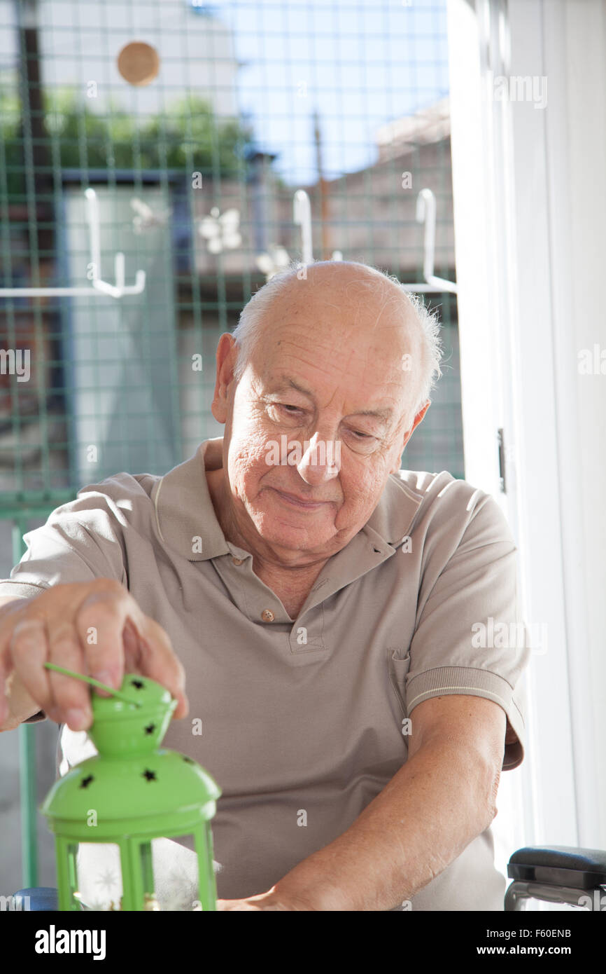 Old senior holding a candle Stock Photo - Alamy