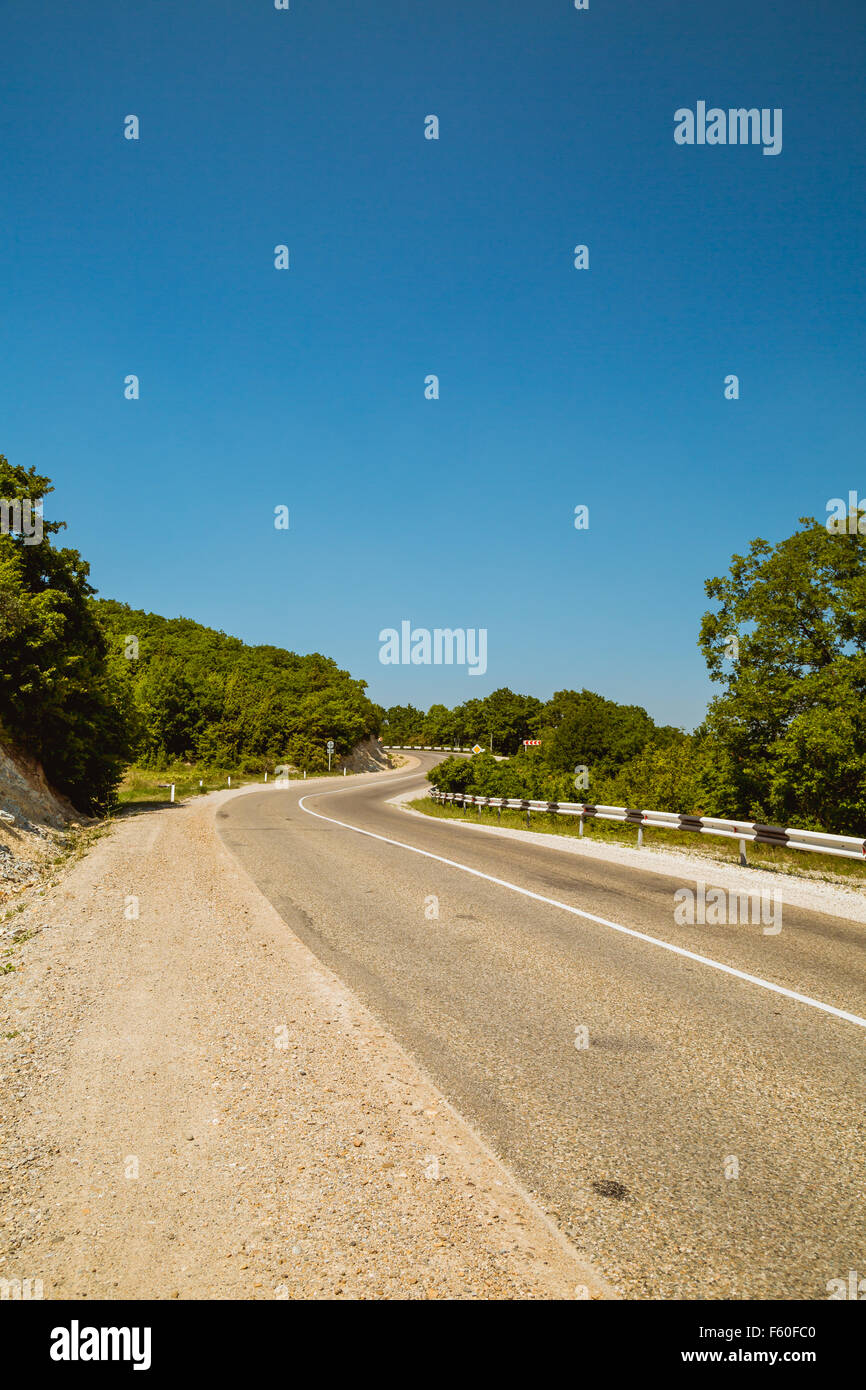 Curved asphalt road in mountains Stock Photo - Alamy