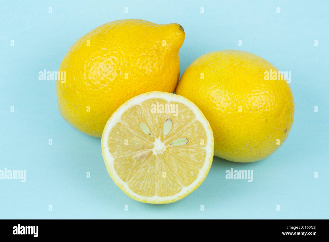 A bunch of lemons on a pale blue background Stock Photo - Alamy