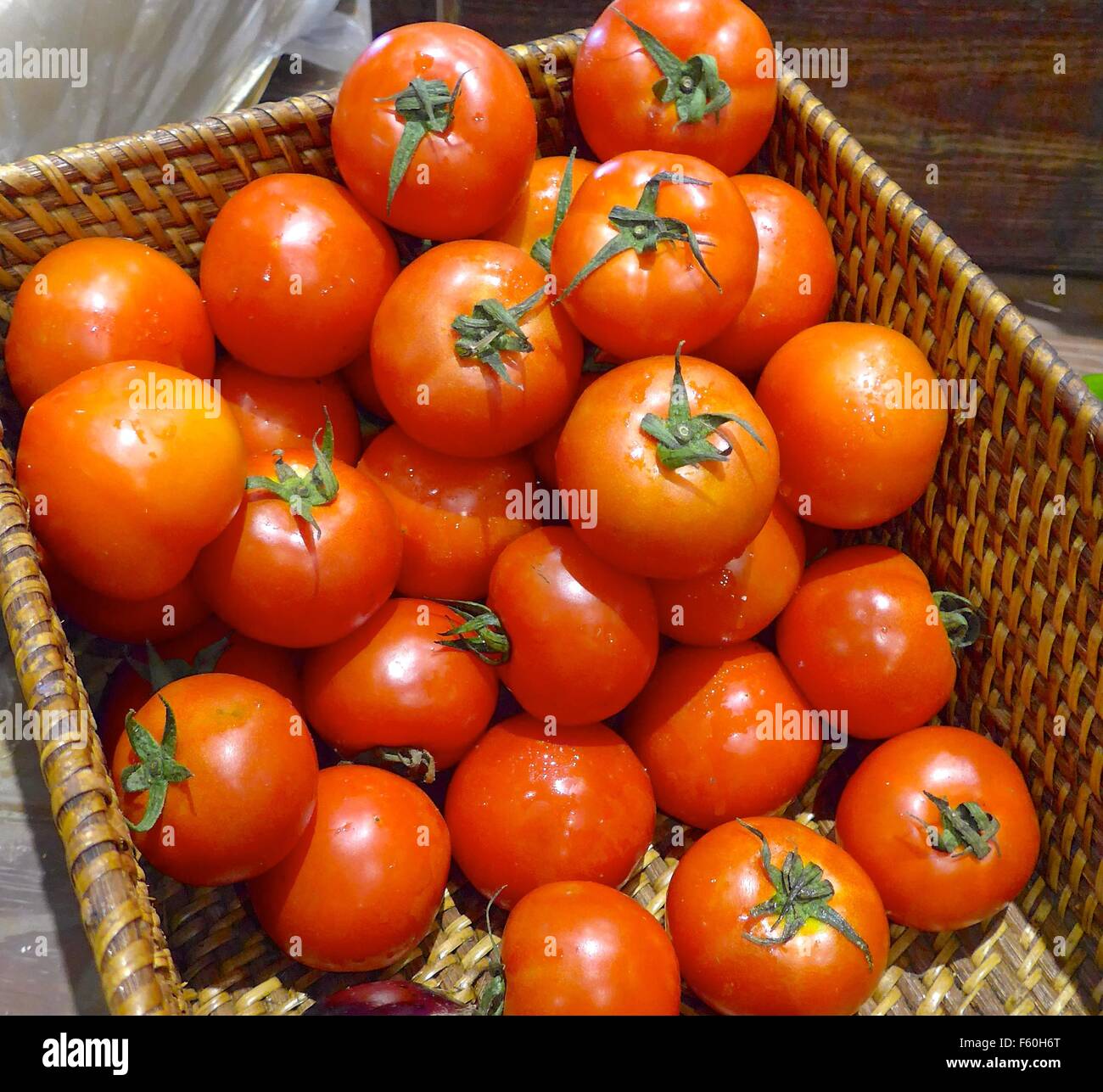 Fresh red tomatoes closeup on the basket Stock Photo - Alamy