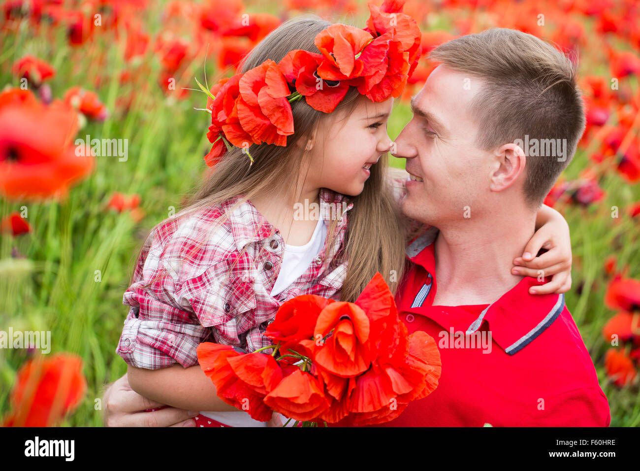 Family on the poppy field Stock Photo - Alamy