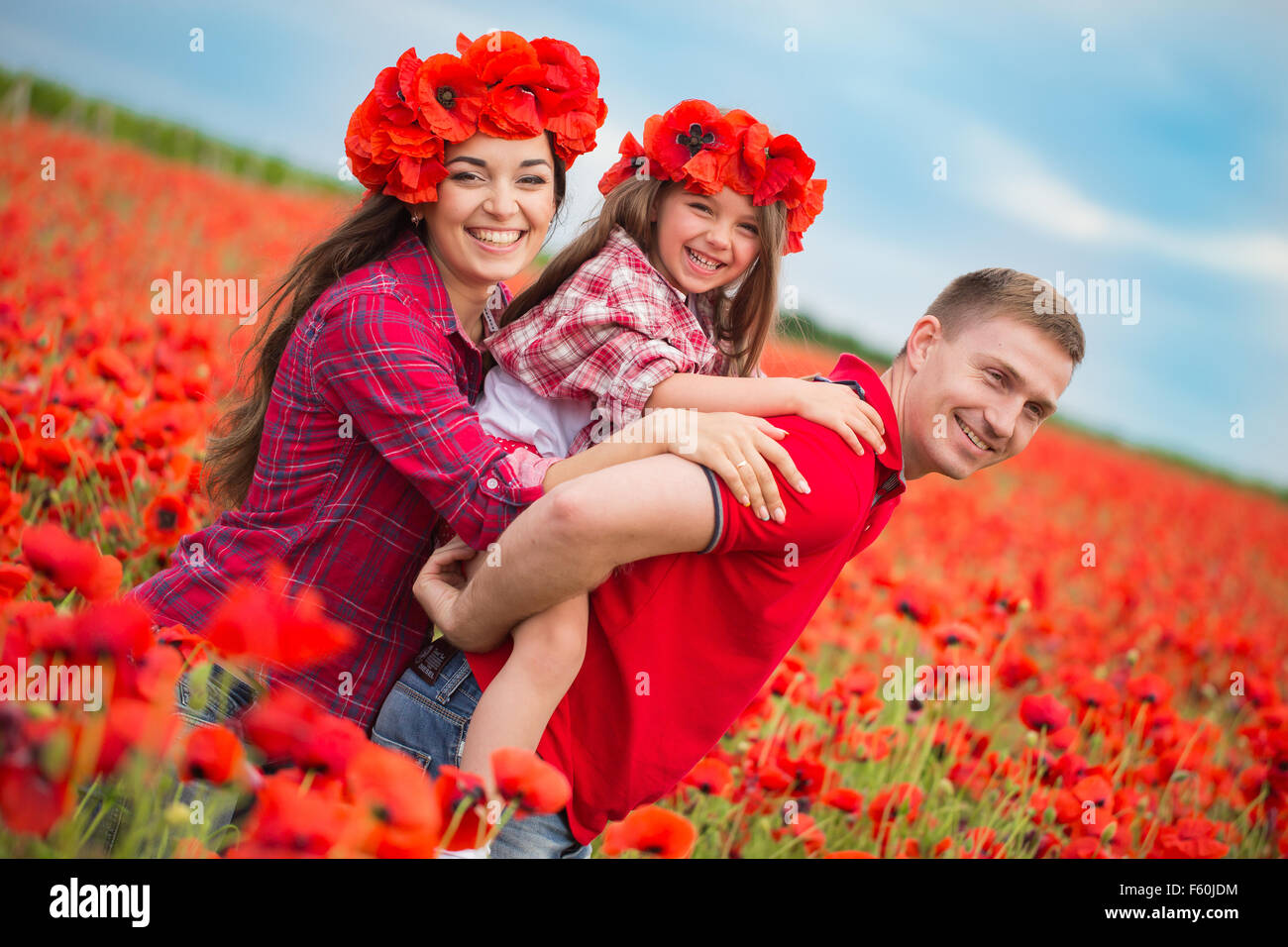 Family on the poppy field Stock Photo - Alamy