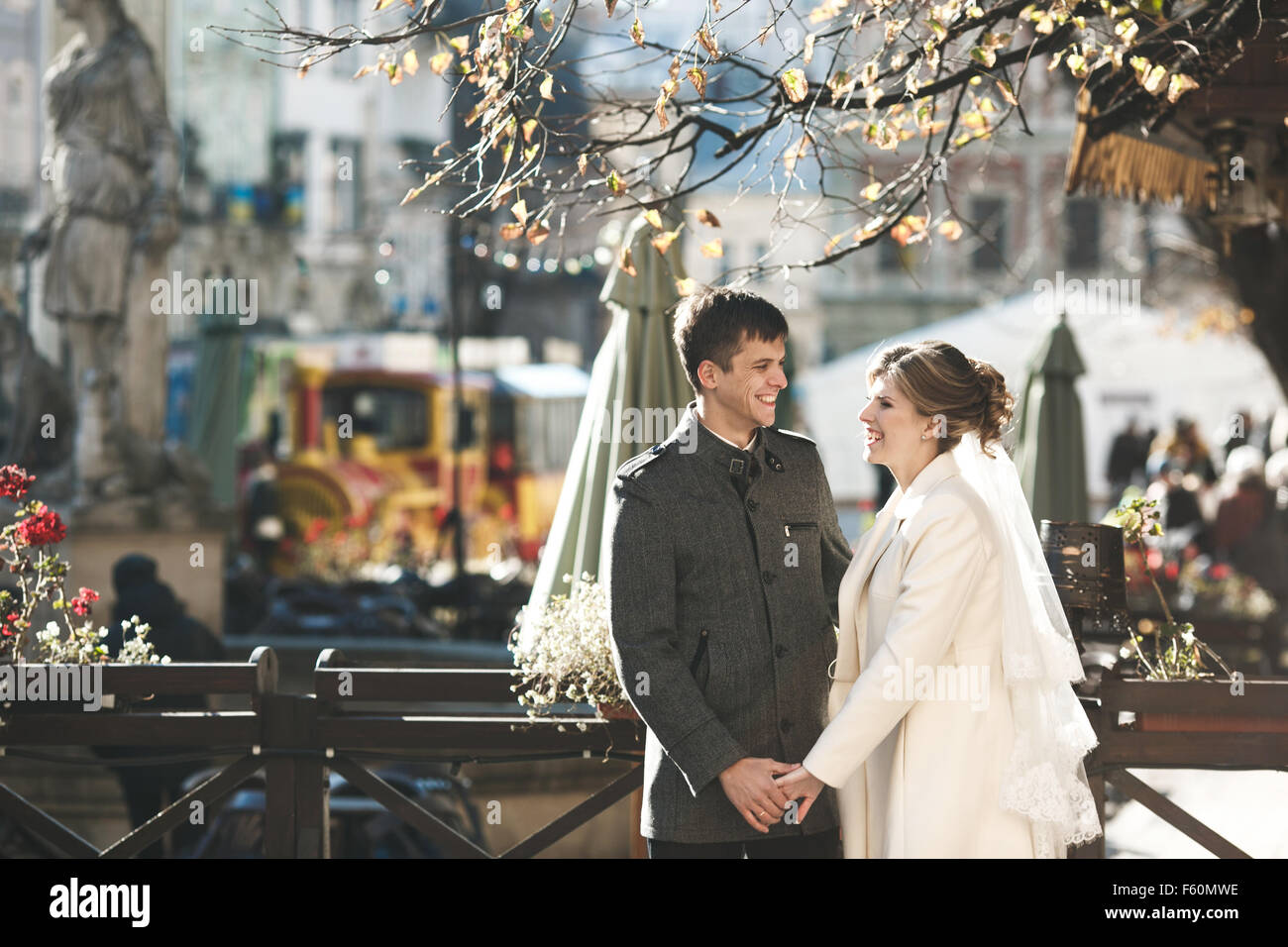 bride and groom in center of the old town Stock Photo - Alamy