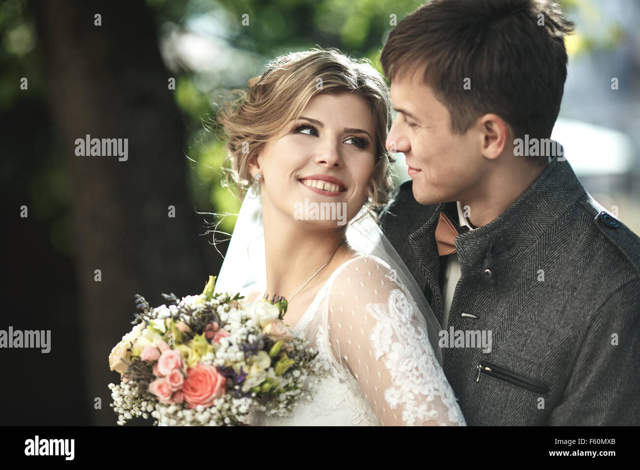 Groom hugs bride Stock Photo - Alamy