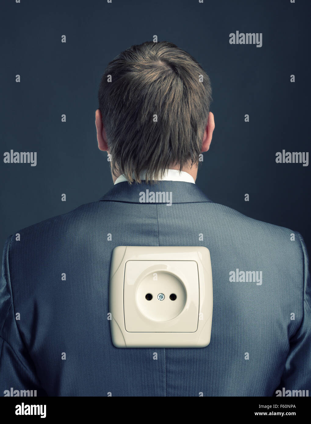 Businessman with electrical outlet on back Stock Photo - Alamy