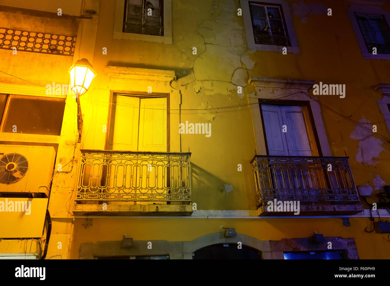 Old building with balconies lighted up with lantern in the evening ...