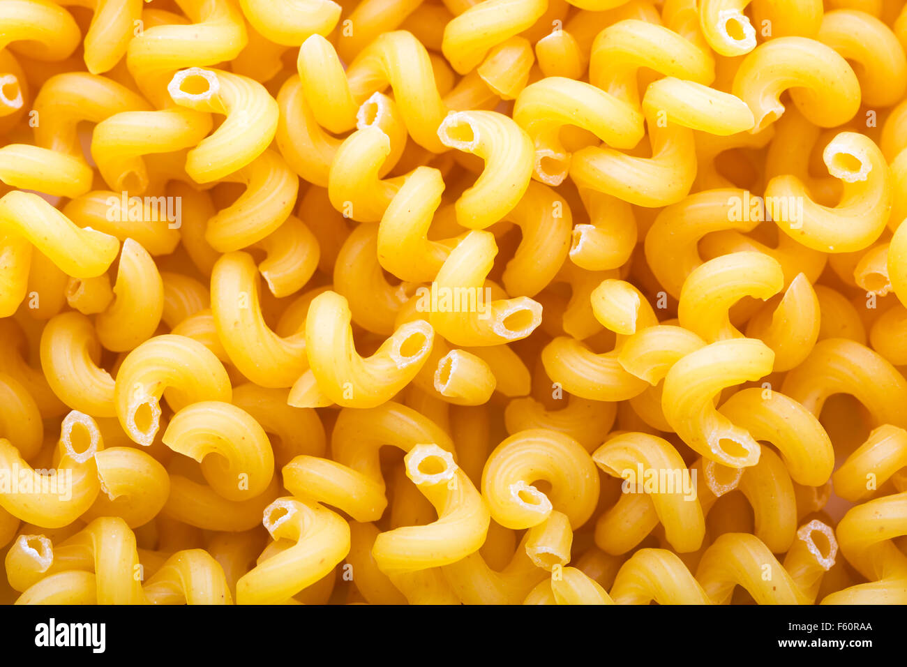 Heap of yellow macaroni closeup. Background Stock Photo - Alamy