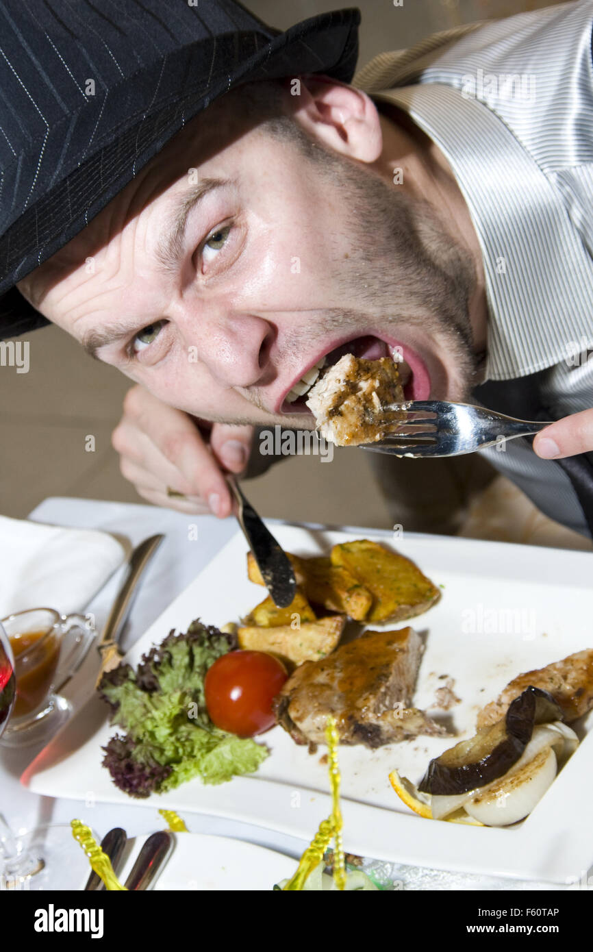 Really hungry man in hat Stock Photo - Alamy