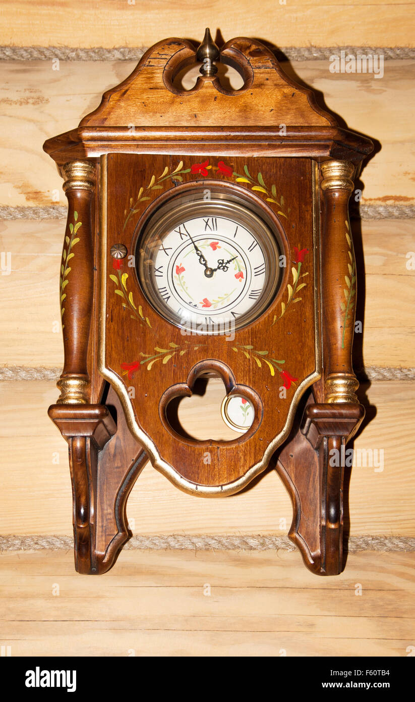 Big vintage wooden clock on the wall Stock Photo - Alamy