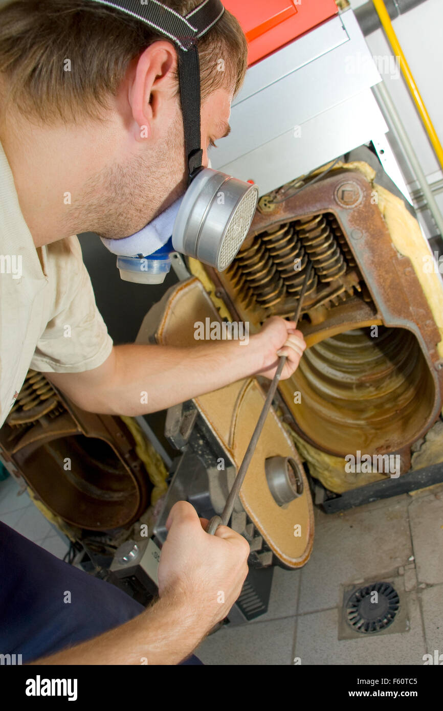 Repair man servicing big gas boiler Stock Photo - Alamy