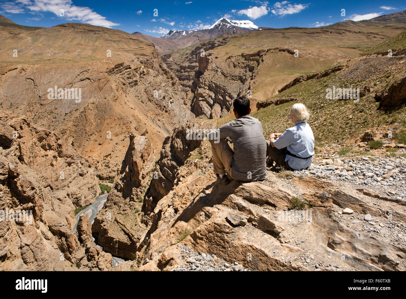 India, Himachal Pradesh, Spiti, tourist and guide enjoying view of deep ...