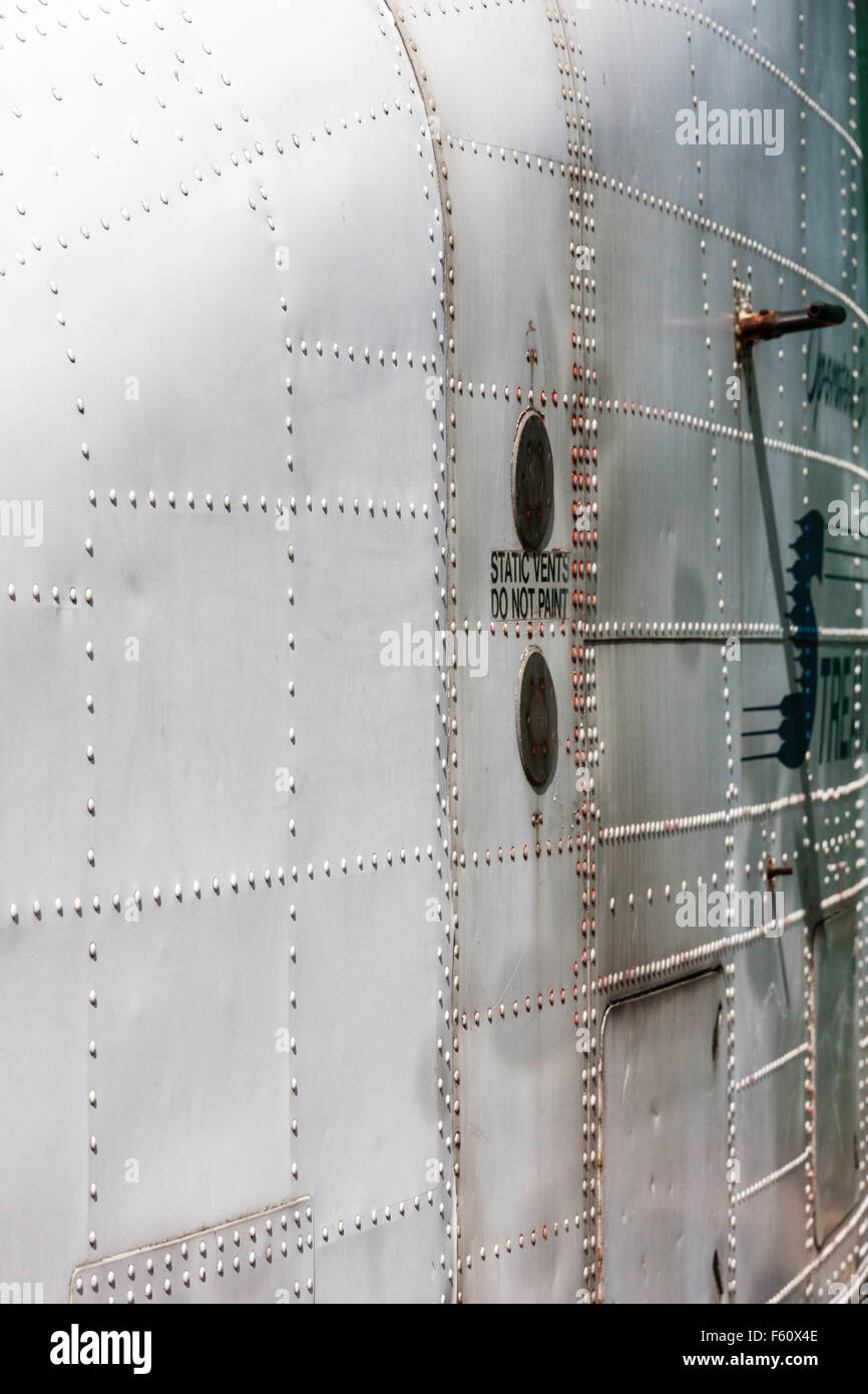 Airplane, side of silver coloured metal fuselage showing panelling and ...