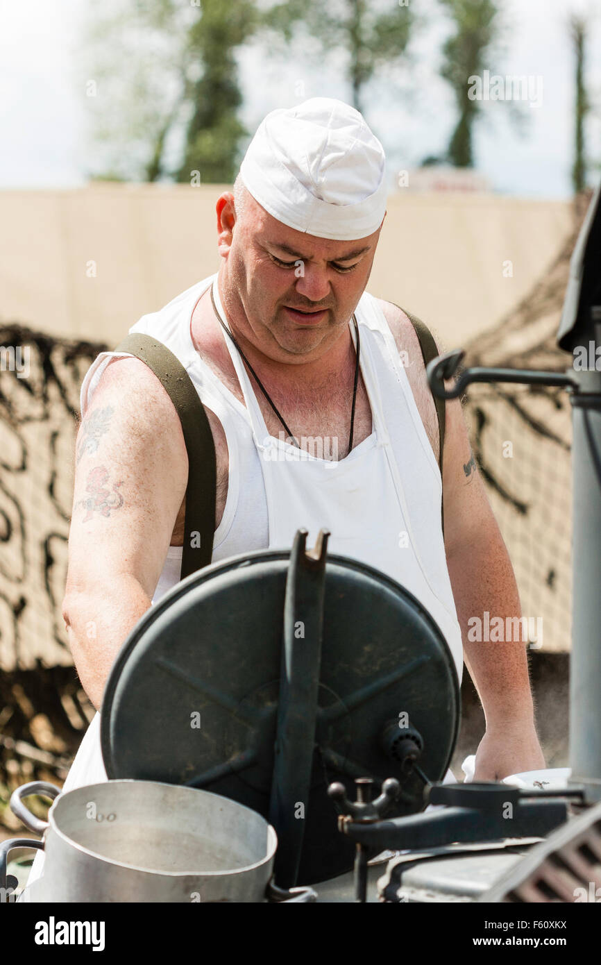 World war two re-enactment. Heavy-set large man, German cook in white t ...