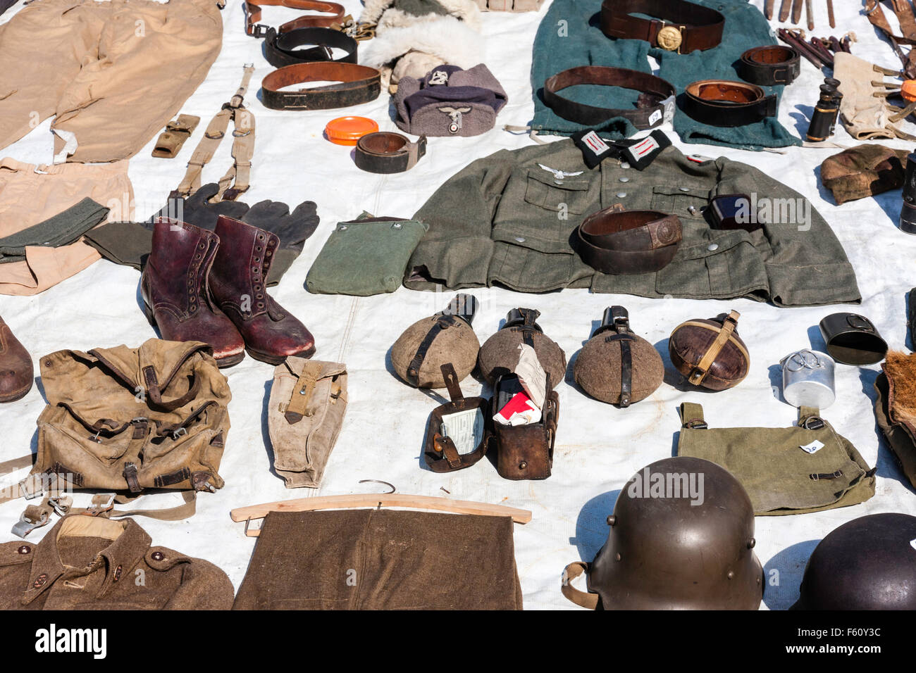 Sheet laid on ground with various types of world war two German uniform ...