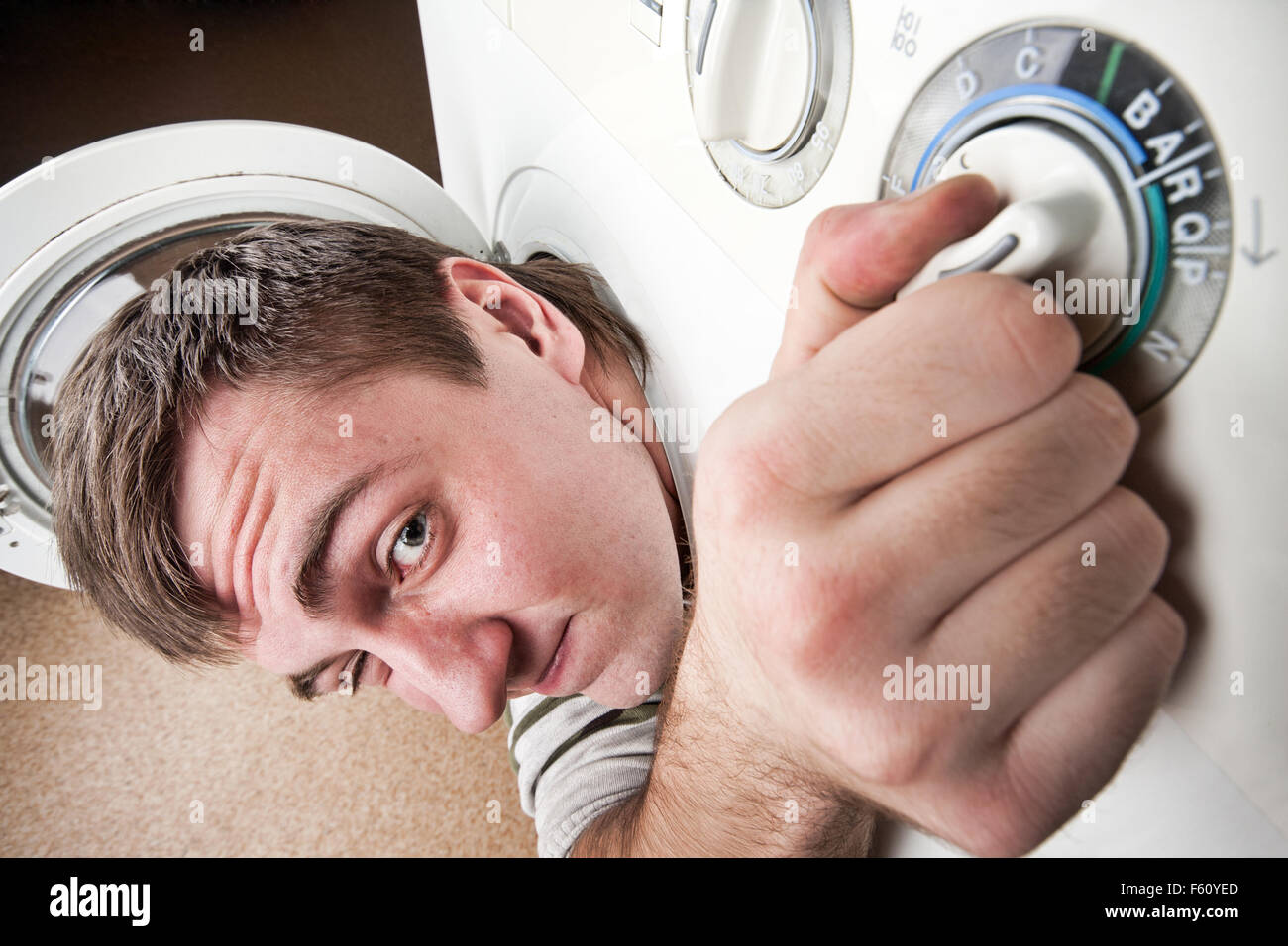 Close-up of surprised man inside washing machine Stock Photo - Alamy