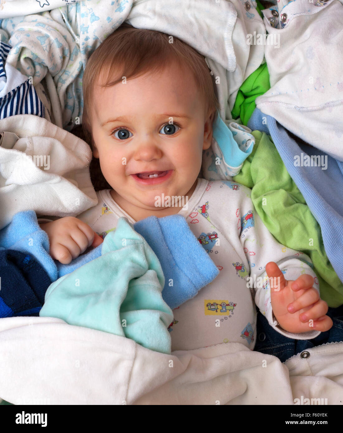 Happy Baby Girl In Heap Of Baby s Wear Stock Photo Alamy happy-baby-girl-in-heap-of-baby-s-wear-stock-photo-alamy