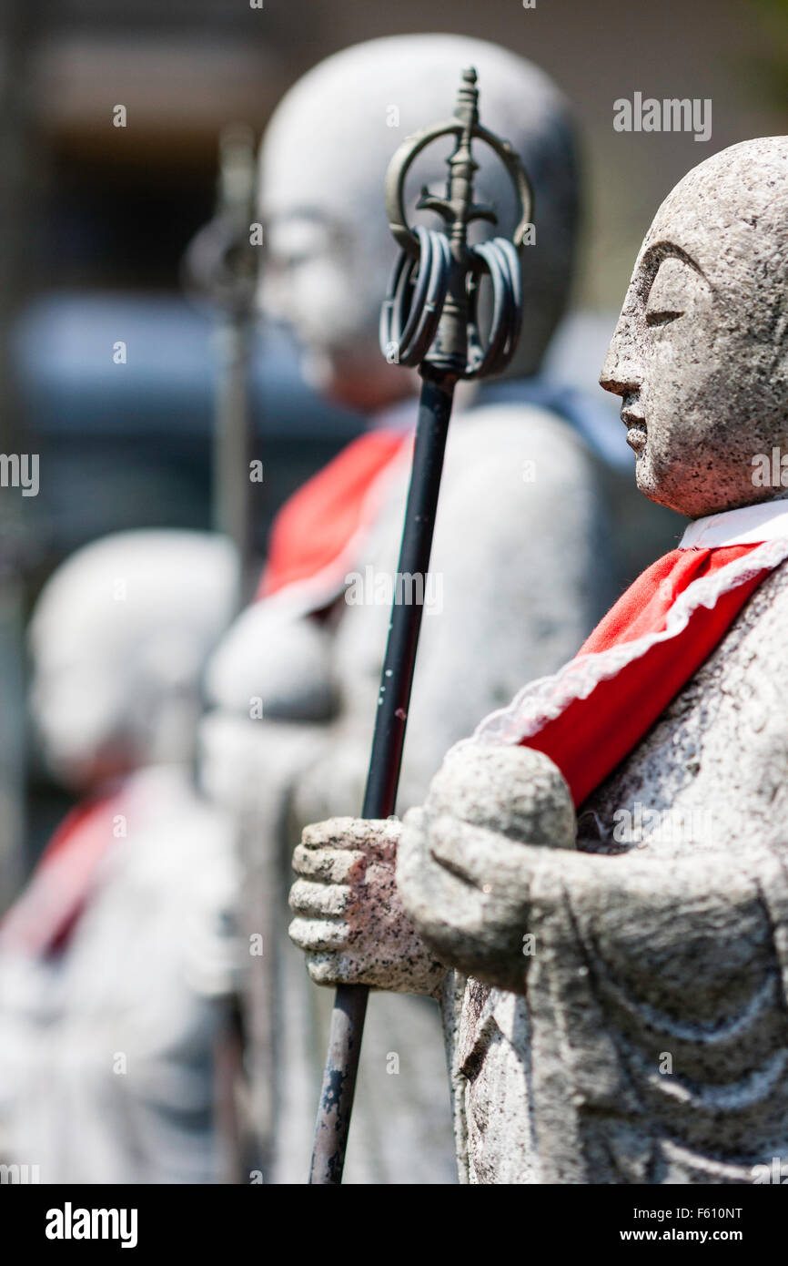 Japan, Kyoto, Seiryo-ji temple. Row of three red-bidded jizo statues ...