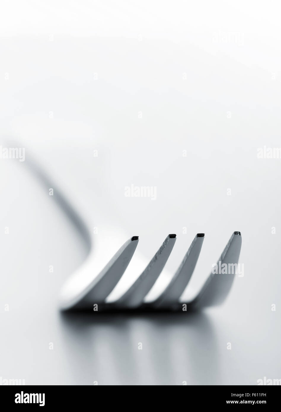 A closeup of silver fork on white background Stock Photo - Alamy