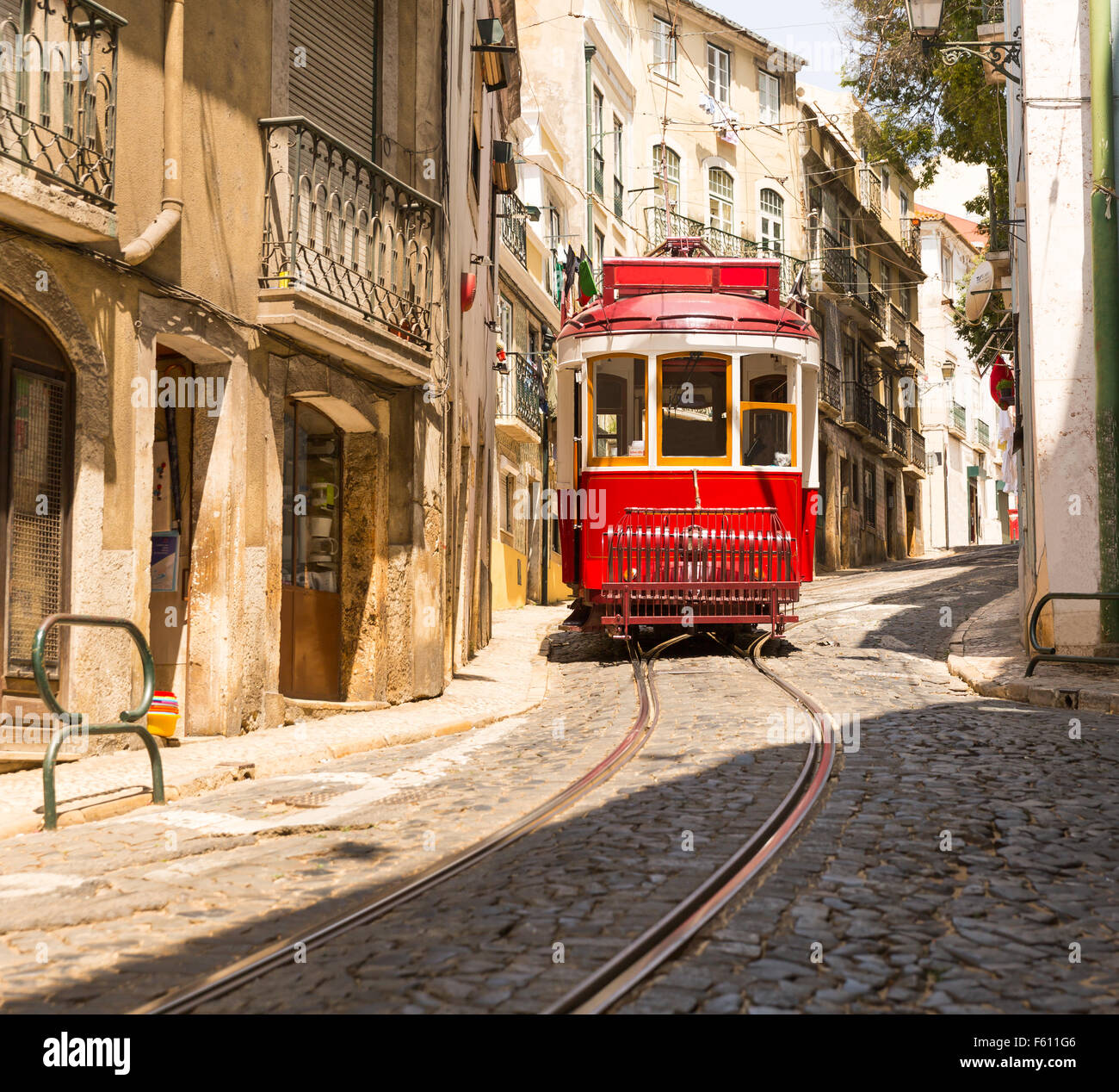 Old red tram on narrow european street in sunny days Stock Photo - Alamy