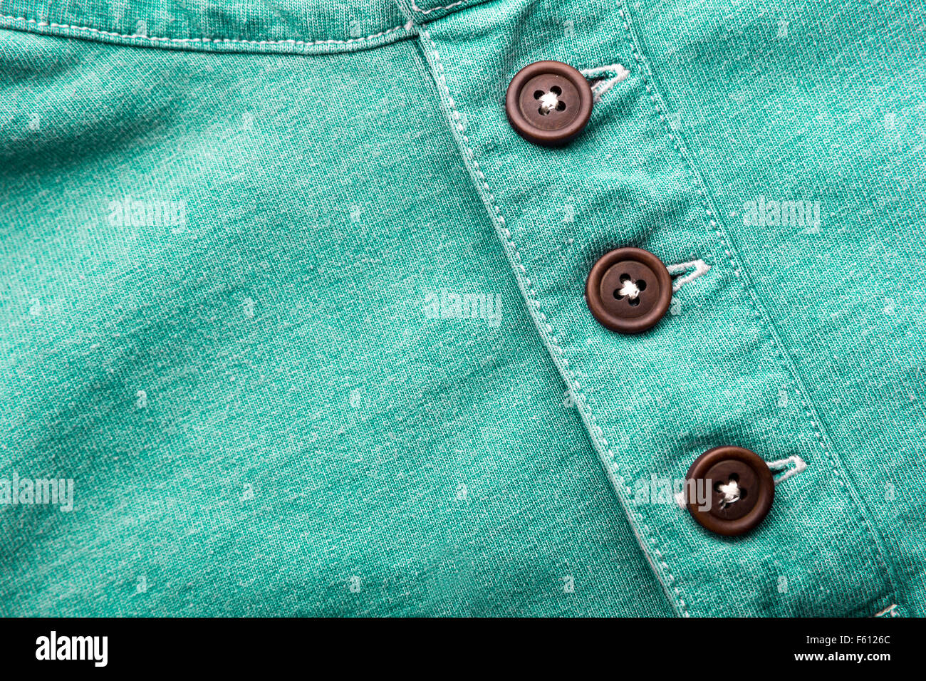 Closeup of green cloth with plastic buttons Stock Photo - Alamy