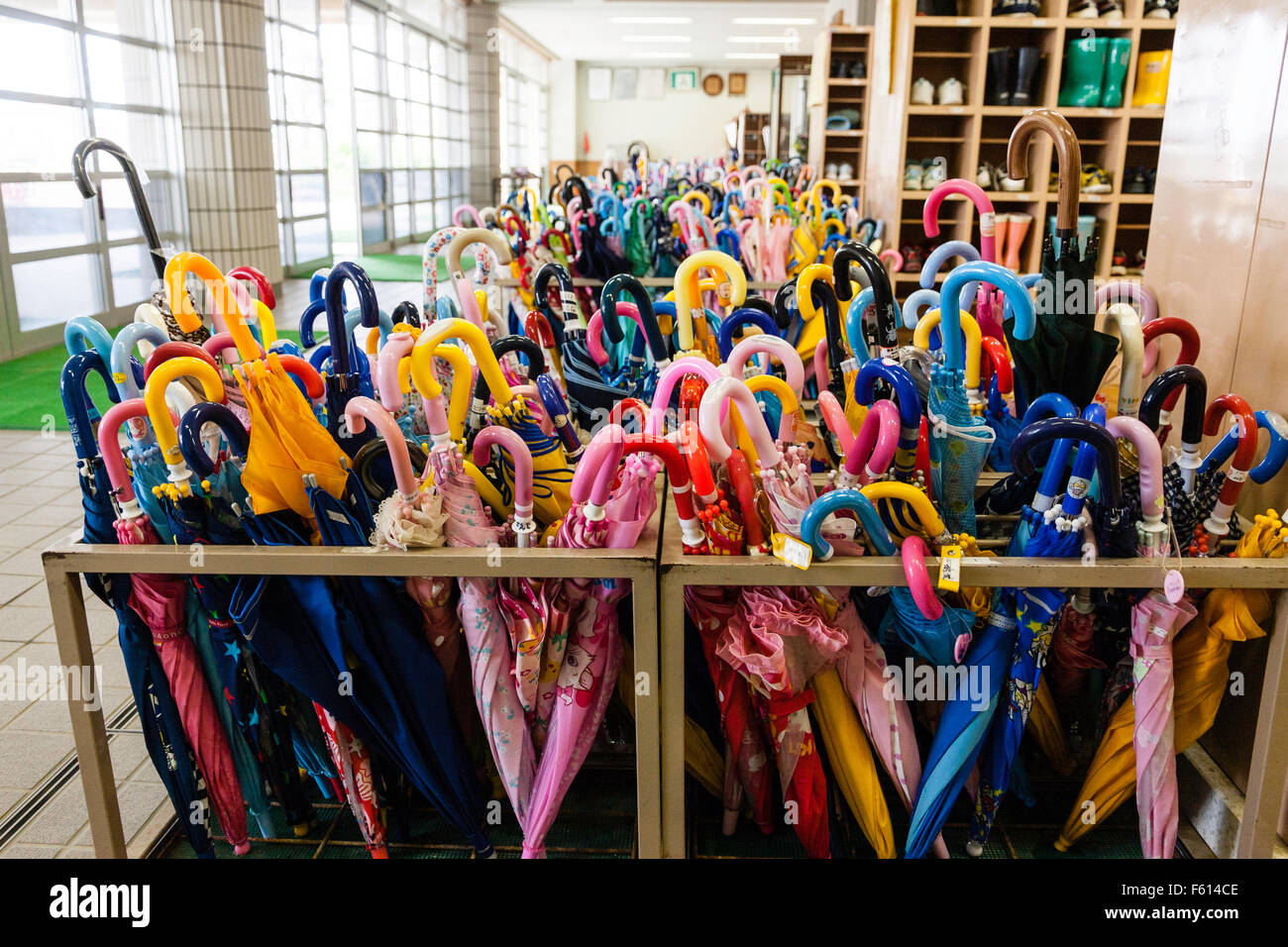 Japan. School hall. Wooden frame rack containing multi-coloured ...