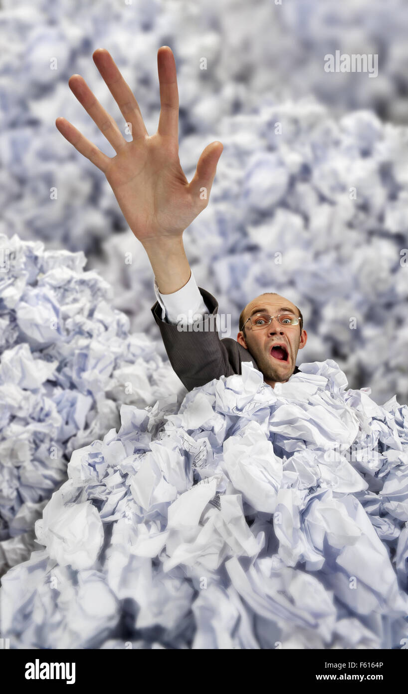 Businessman sinking in big heap of crumpled papers and asking for help ...