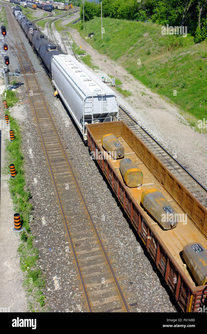 A long freight train passing under a bridge in the Canadian city of ...