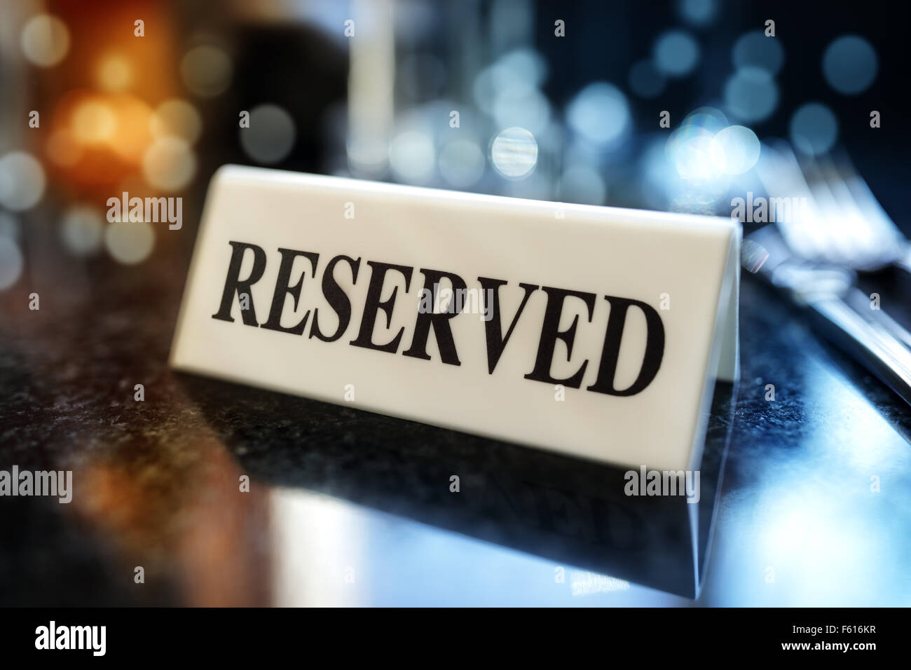 Restaurant reserved table sign with places setting and wine glasses ...