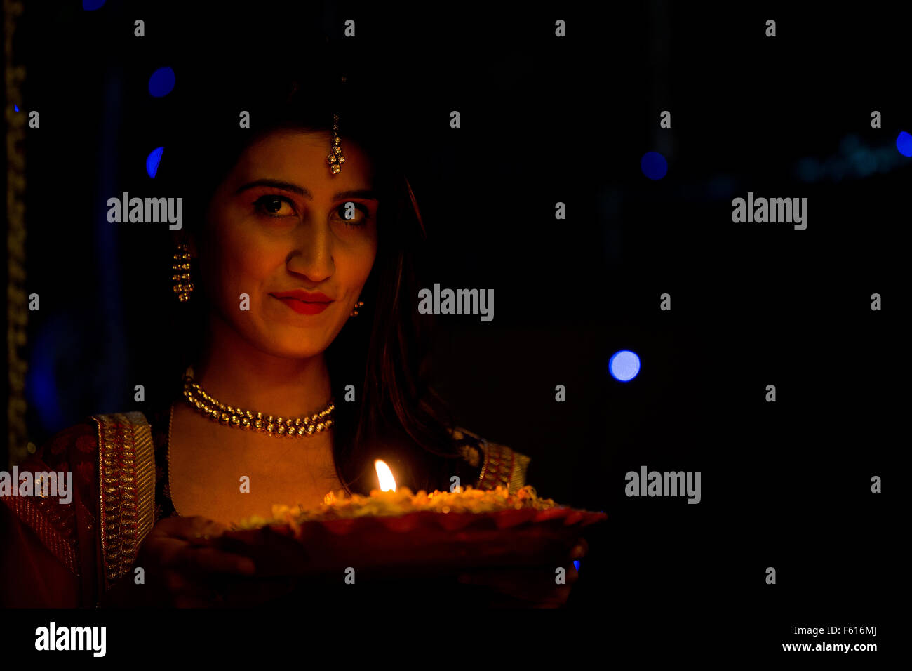 Indian woman with diya during diwali hi-res stock photography and ...