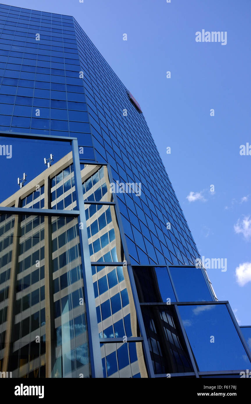 A skyscraper is reflected in the side of another skyscraper in the ...
