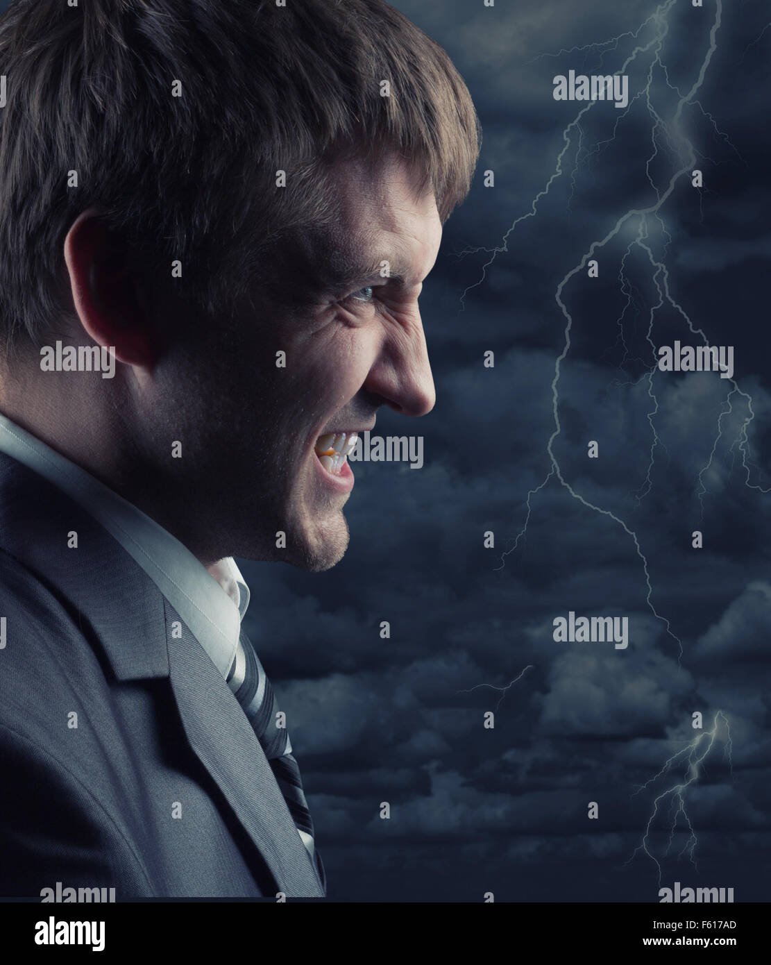 Angry businessman against storm at night Stock Photo - Alamy