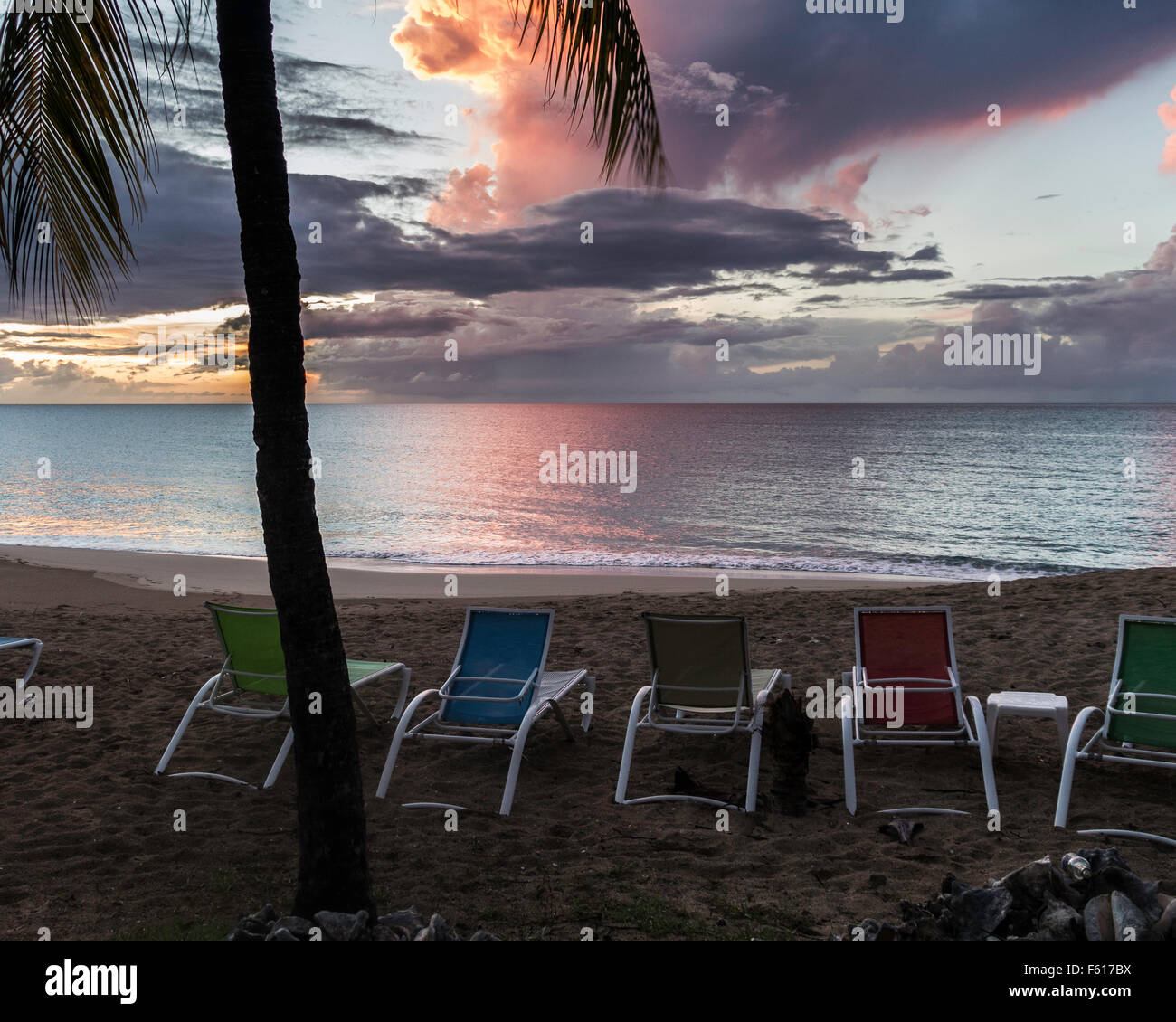 A beautiful sunset showing the beach and beach chairs at a resort in St ...