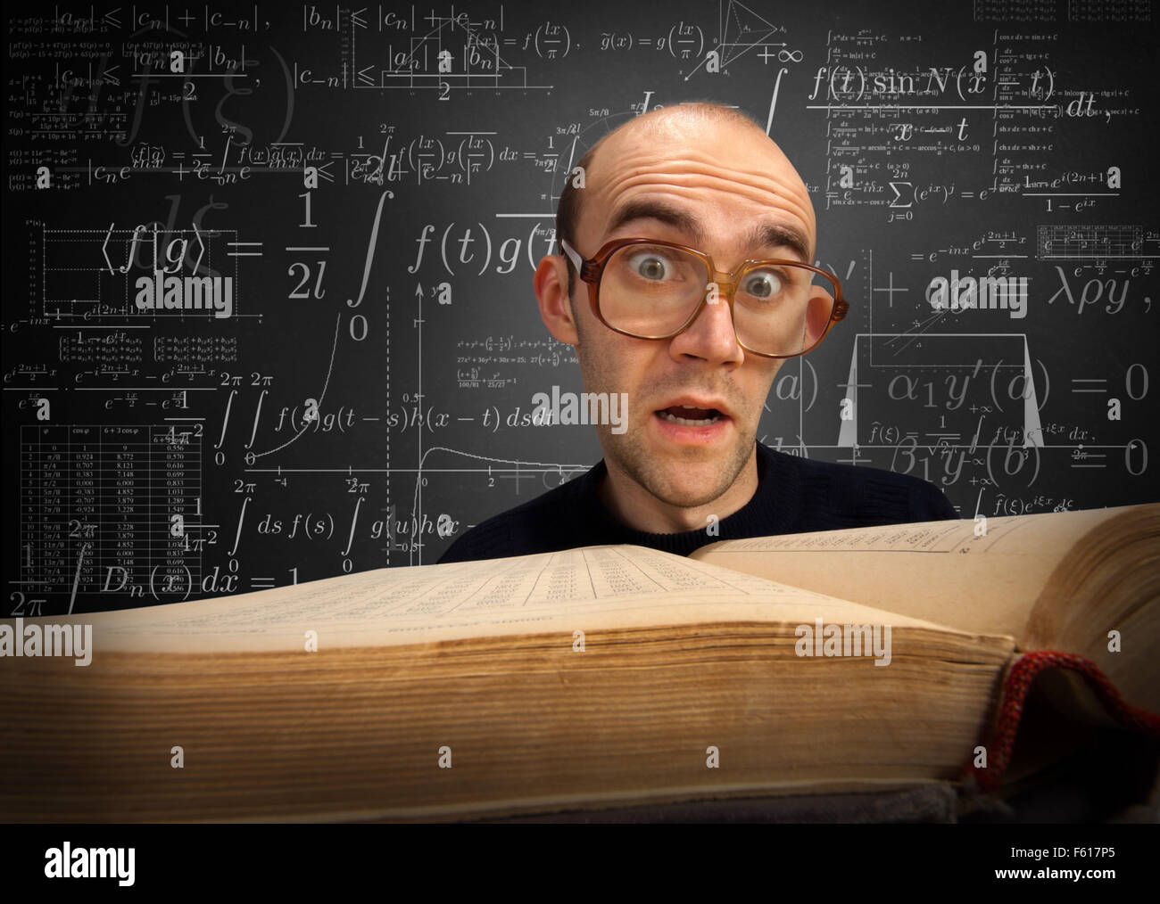 Surprised nerd student looking to textbook on math Stock Photo - Alamy
