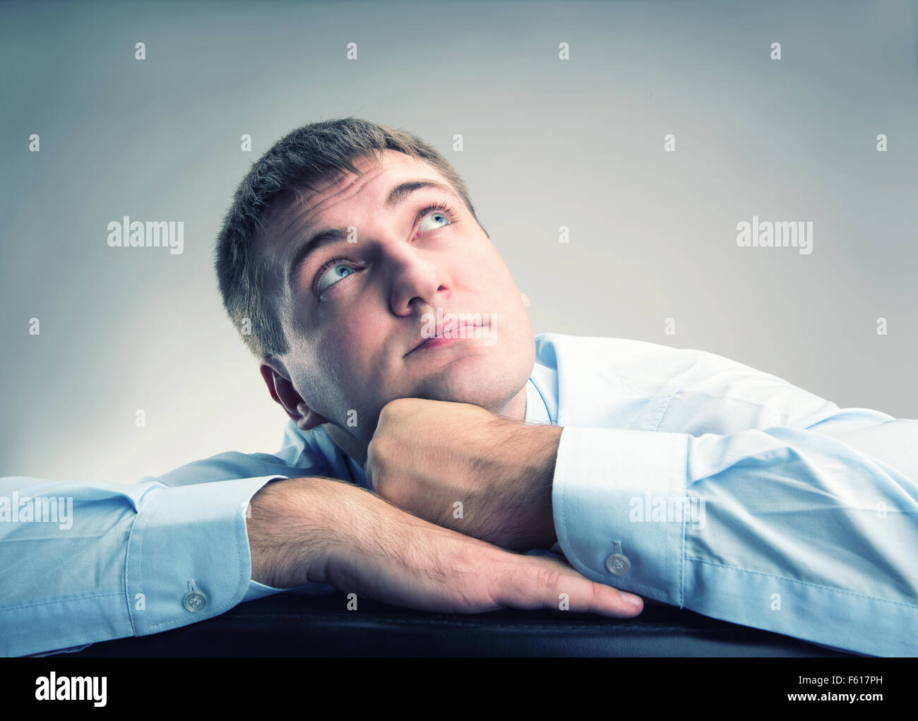 Lonely office worker looking thoughtfully up Stock Photo - Alamy