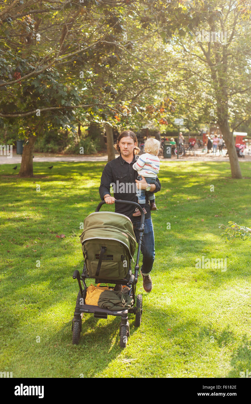 Man pushing baby carriage hi-res stock photography and images - Alamy