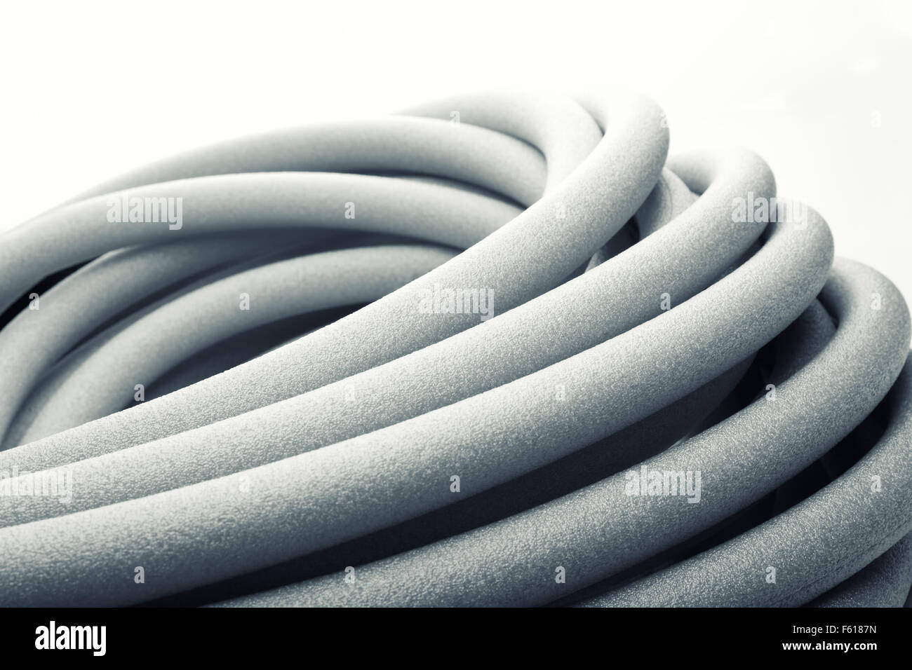 Closeup view of rolls of thermal insulation foam pipes Stock Photo - Alamy